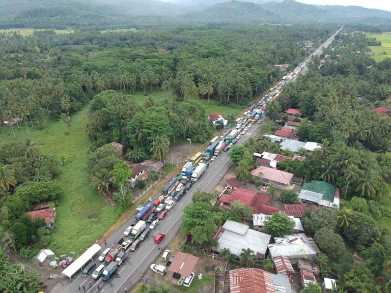 Aerial View of Vehicles Entering Butuan City Stuck in Long Traffic