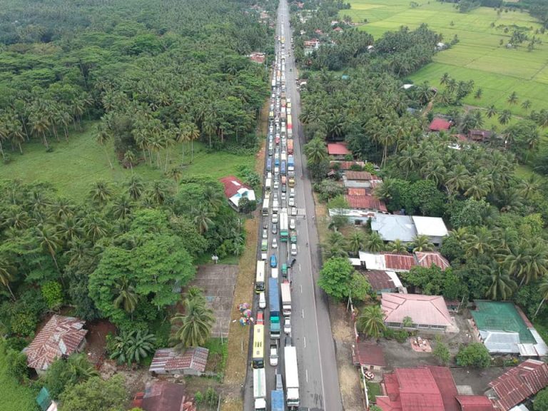 Aerial View of Vehicles Entering Butuan City Stuck in Long Traffic